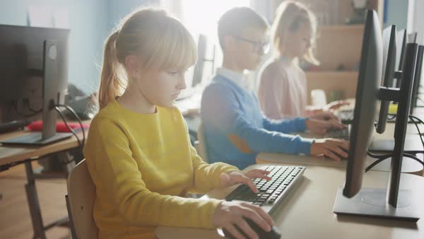 Elementary School Computer Science Classroom: Cute Little Girl Uses ...