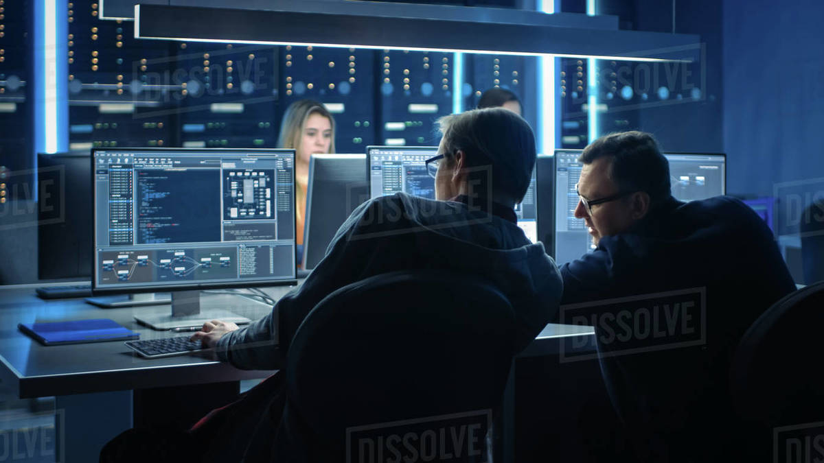 Team of IT Programers Working on Desktop Computers in Data Center ...