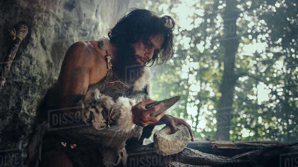 Primeval Caveman Wearing Animal Skin Holds Sharp Stone and Makes First ...