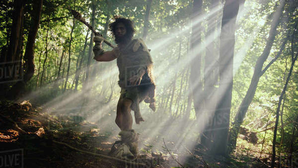 Portrait of Primeval Caveman Wearing Animal Skin and Fur Hunting with a ...