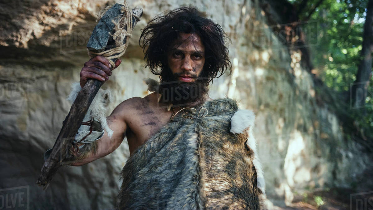 Portrait of Primeval Caveman Wearing Animal Skin Holding Stone Tipped ...