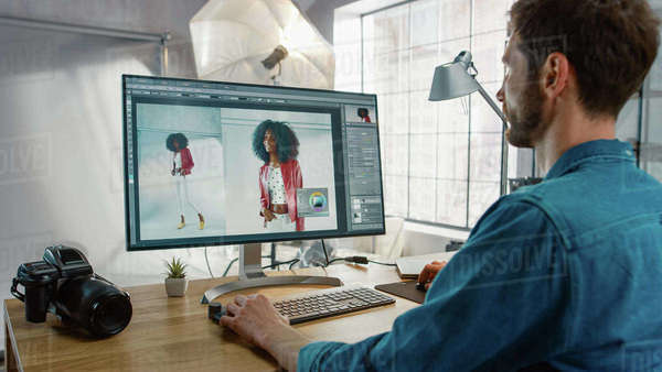 Professional Photographer Sitting at His Desk Uses Desktop Computer in ...