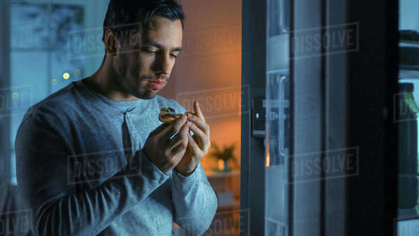 At Night in the Kitchen Handsome Attractive Young Man is Eating a ...