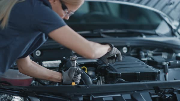 Slow Motion Portrait Footage of a Female Mechanic Working on a Vehicle ...