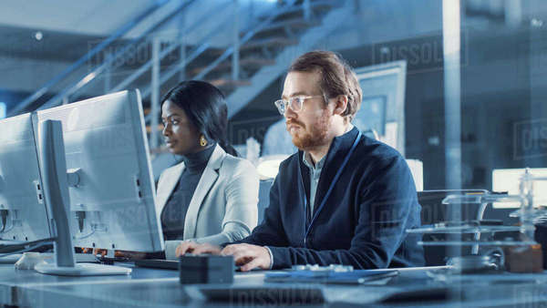 Two Electronics Development Engineers Working on Computers. Team of ...