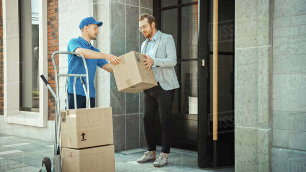 Delivery Man Pushes Hand Truck Trolley Full of Cardboard Boxes Hands ...