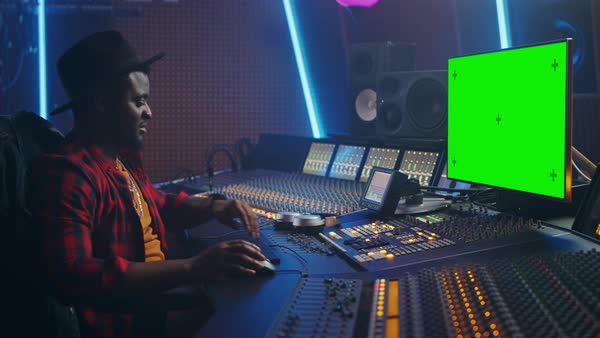 Stylish Audio Engineer / Producer Working in Music Record Studio, Uses ...