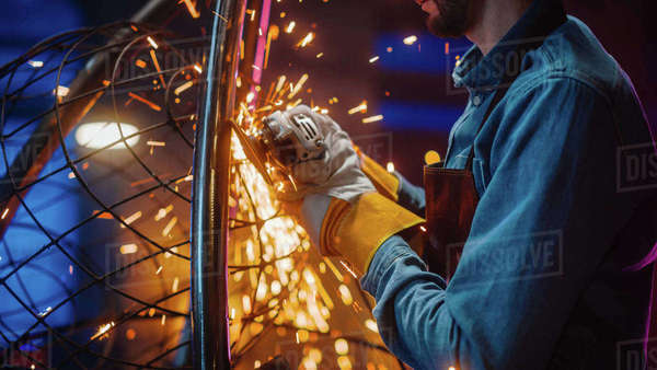 Close Up of a Talented Innovative Artist Using an Angle Grinder to Make ...