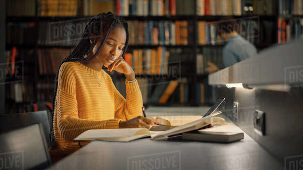 University Library: Gifted Girl uses Laptop, Writes Notes for the Paper ...