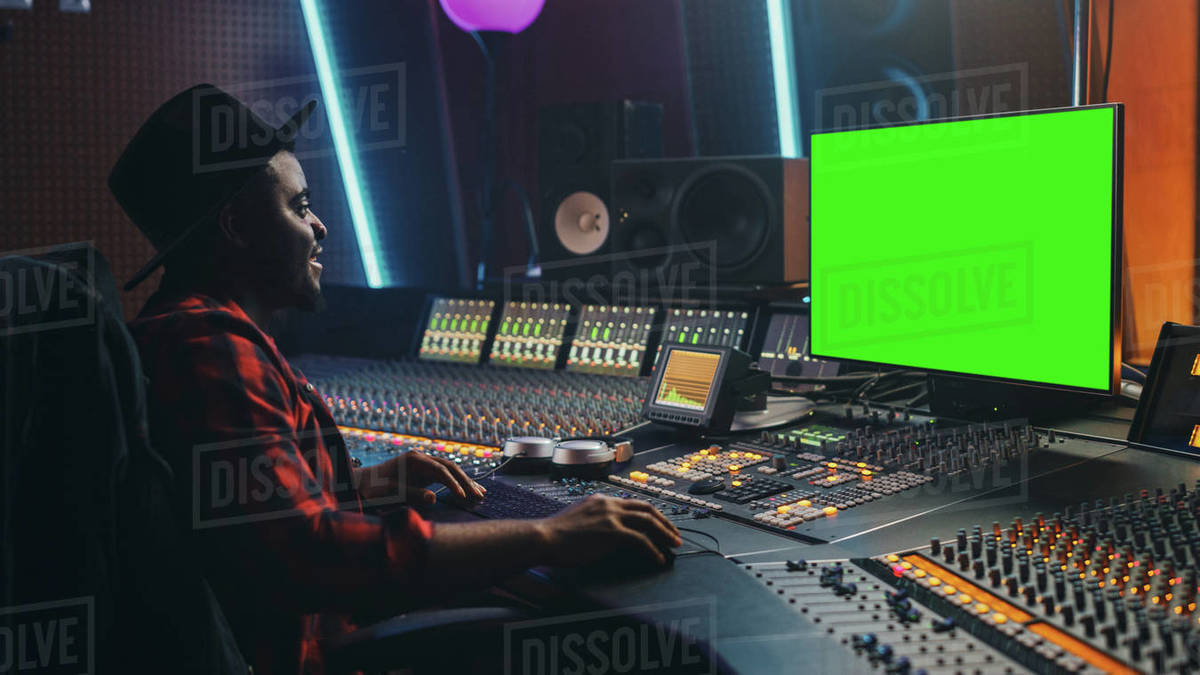 Stylish Audio Engineer / Producer Working in Music Record Studio, Uses ...