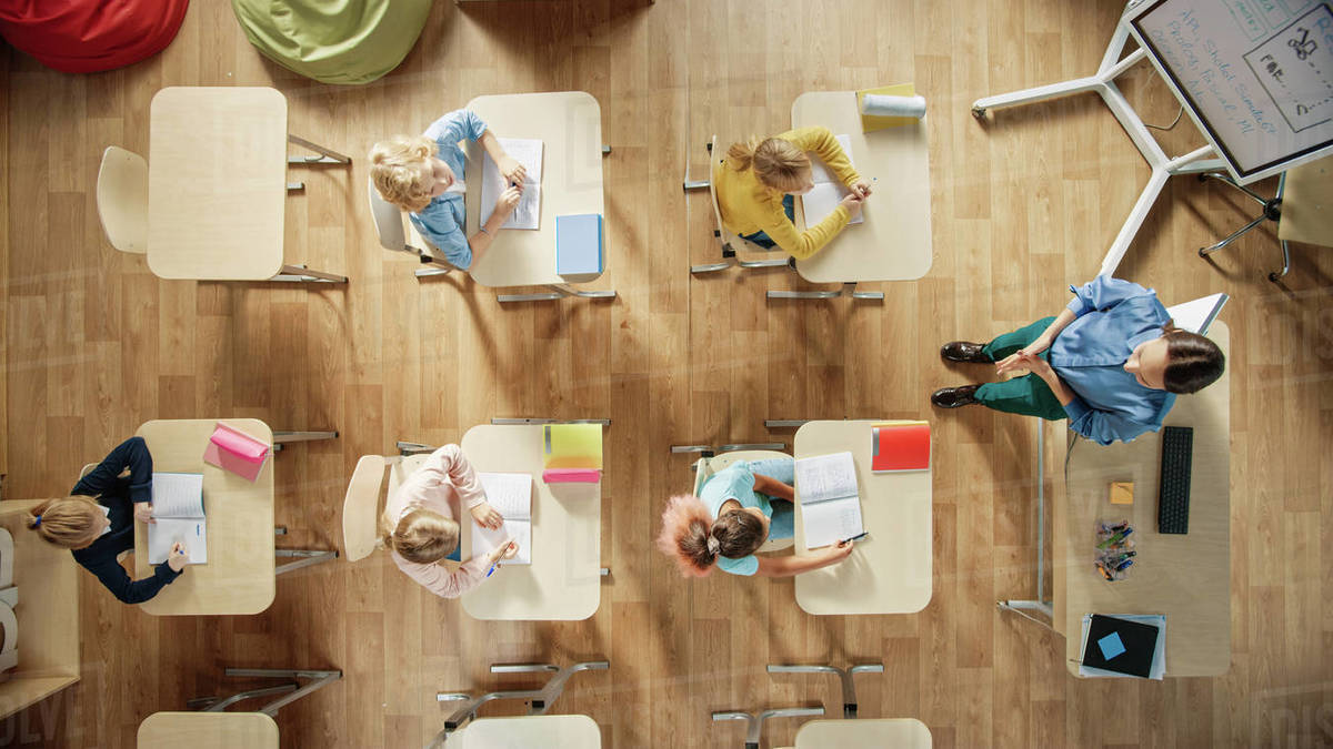 Bright Elementary School Classroom: Children Sitting at their School ...