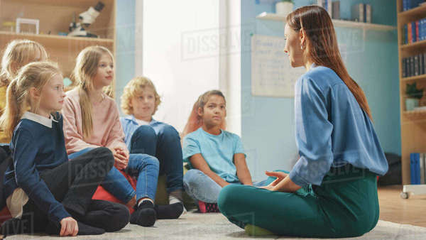 Elementary School Creativity Class: Children Sitting on Carpet while ...