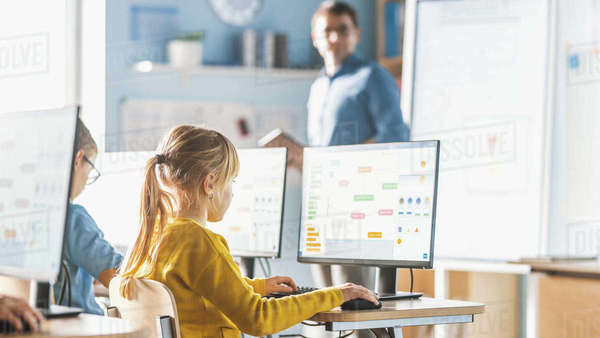 Elementary School Computer Science Classroom: Cute Little Girl Uses ...