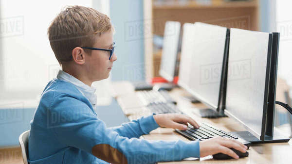Elementary School Computer Science Classroom: Cute Little Boy wearing ...