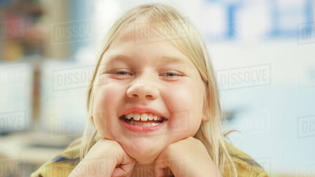 Portrait of a Cute Little Girl with Blond Hair Sitting at her School ...