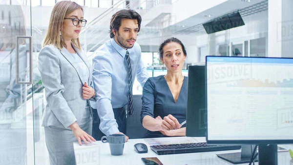 In Bright Modern Office: Office Worker Sitting and Working at Her ...