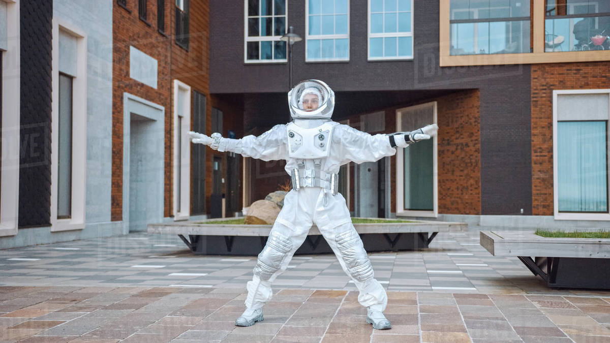 Handsome Man in Spacesuit is Dancing in a Neighbourhood. Astronaut is ...