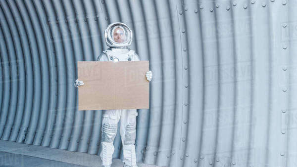 Happy Man in Spacesuit is Standing in a Metal Tube Tunnel and Holding a ...