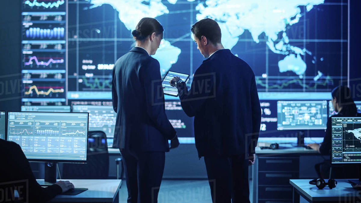 Project Manager and Computer Science Engineer Talking while Using A Digital Tablet Computer ...