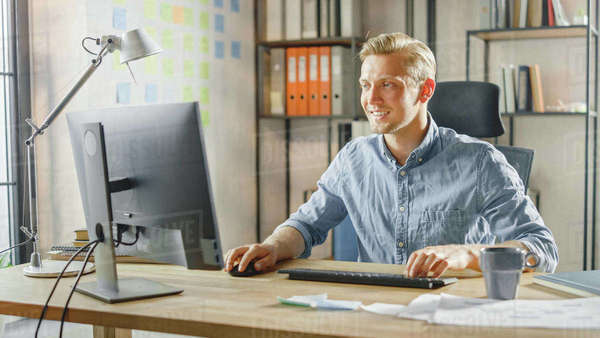 Creative Entrepreneur Sitting at His Desk Works on Desktop Computer in ...