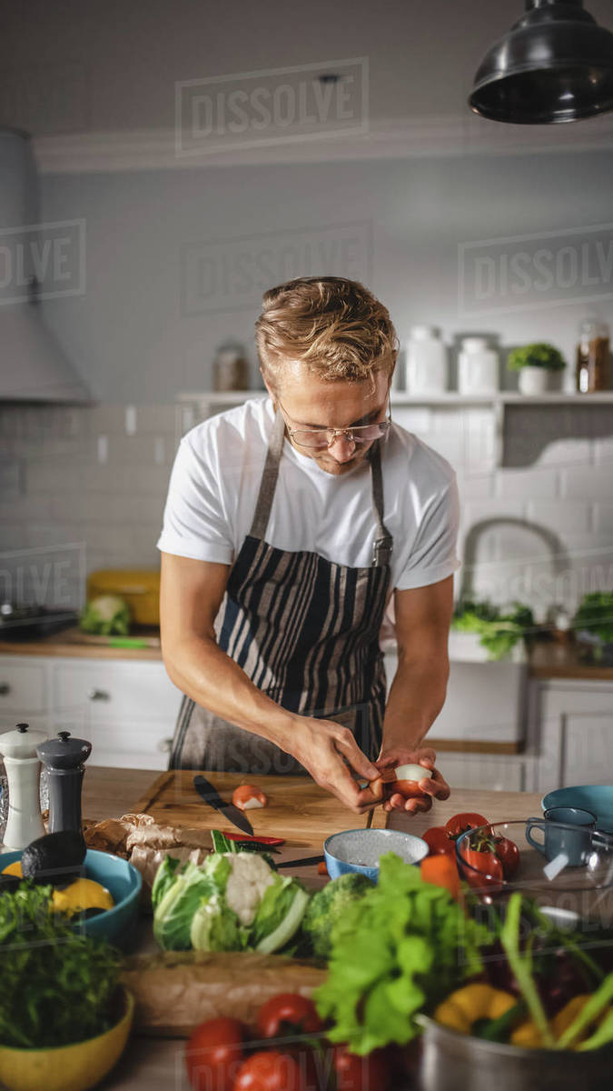 Handsome Man in White Shirt and Apron is Making a Healthy Organic Salad ...