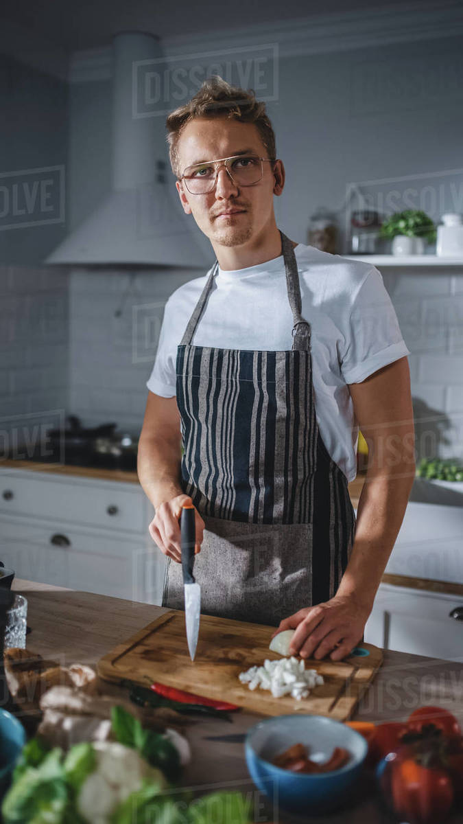 Shot of Handsome Cook in White Shirt and Apron Holding Sharp Knife and ...
