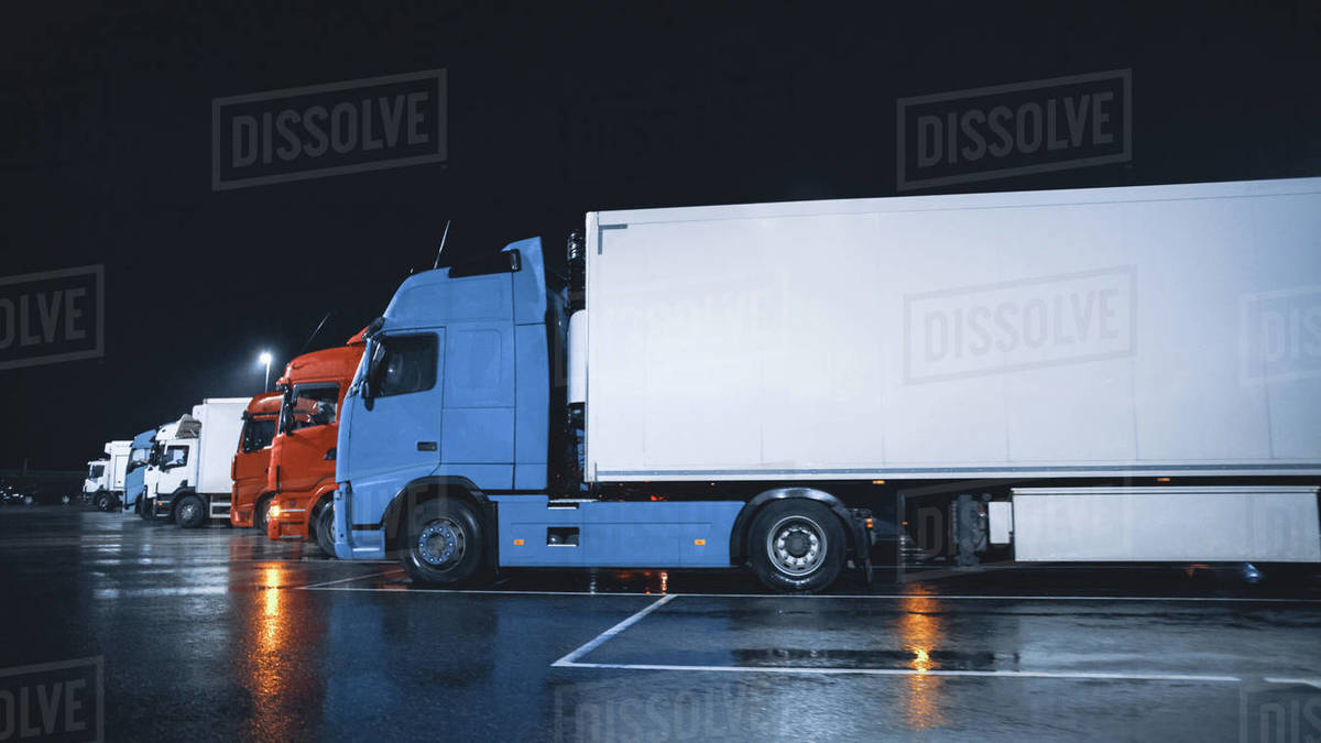 Line of Semi-Trucks with Cargo Trailer Drives Standing on the Overnight ...