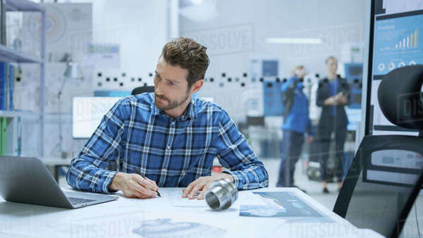 Modern Industrial Factory: Industrial Engineer Sitting at His Desk ...