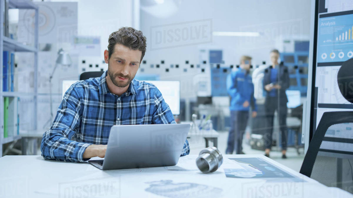 Modern Industrial Factory: Industrial Engineer Sitting at His Desk ...
