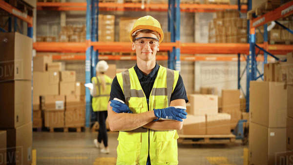 Handsome Smiling Worker Wearing Hard Hat, Standing with Crossed Arms in ...