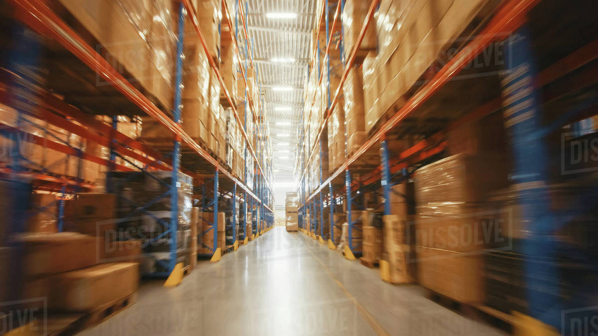 Blurred Motion Moving View Through a Retail Warehouse full of Shelves ...