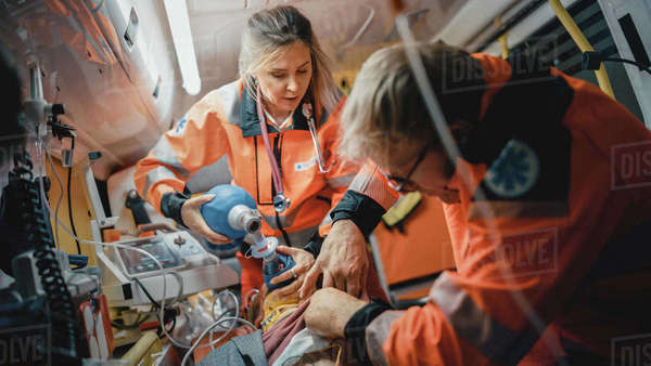 Paramedics Provide Medical Help to an Injured Patient on the Way to a ...