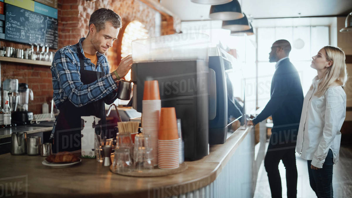Barista making customer coffee orders in a local coffee shop - Stock ...