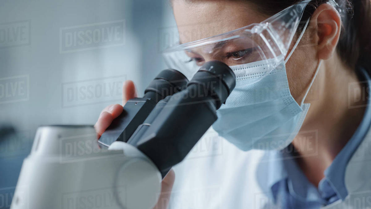 Macro Close Up Shot of a Female Scientist in Face Mask and Goggles ...