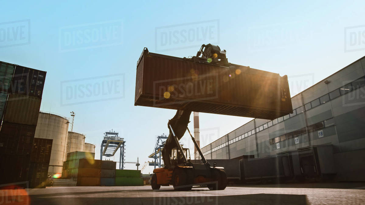 Modern Container Handler Carrying a Large Red Steel Shipping Cargo ...