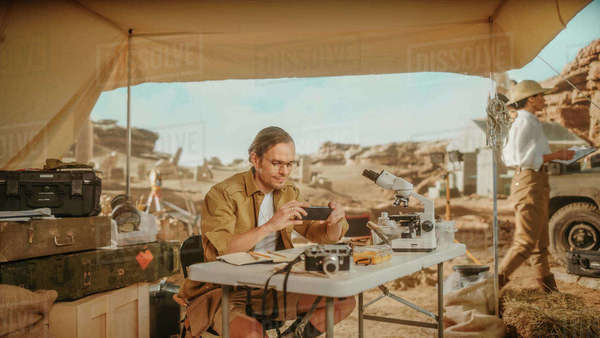 Male Archaeologist Doing Research - Stock Photo - Dissolve