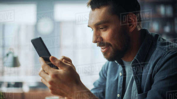 Man Using Smartphone in Cozy Living Room at Home - Royalty-free Stock ...