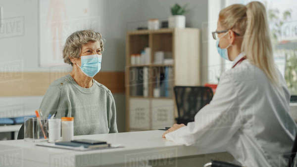 Female Family Doctor is Speaking to a Senior Woman During Consultation ...