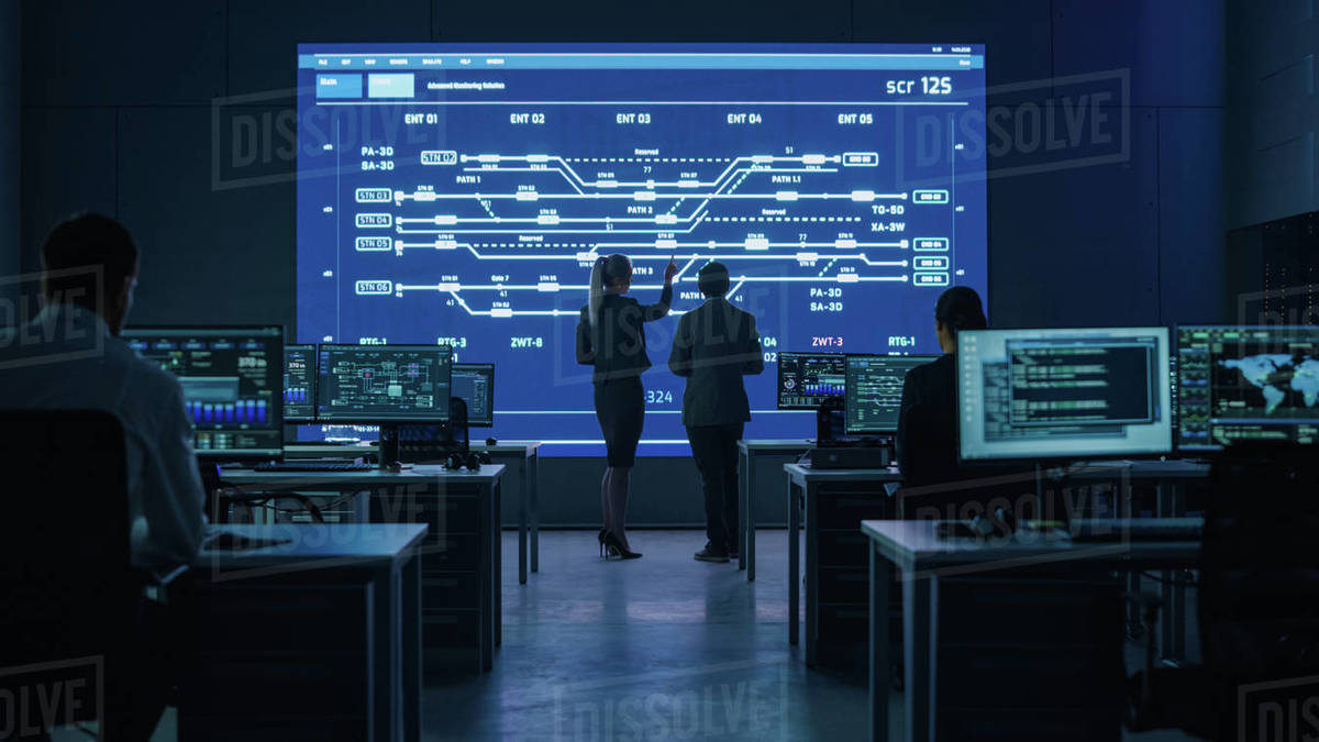 Project Manager and Computer Science Engineer Talking while Using Big ...