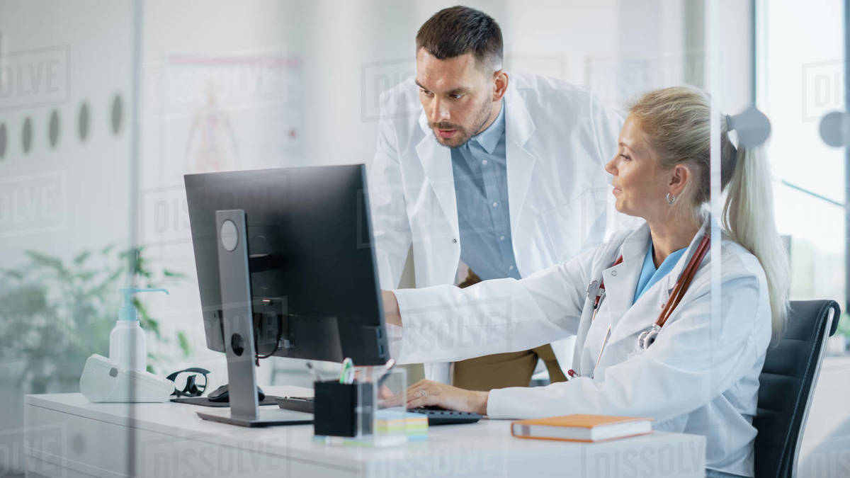 Hospital Medical Doctor's Office: Two Professional Physicians Talking ...