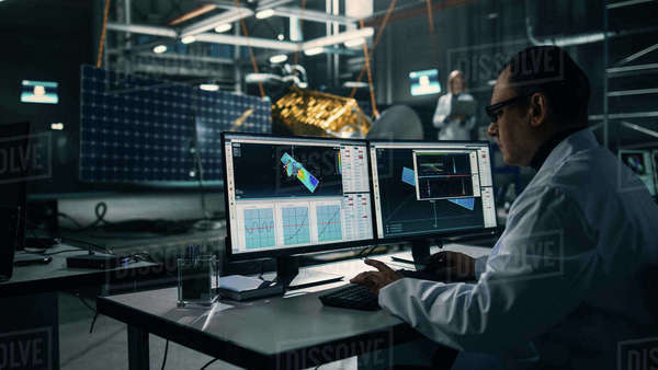 Male Engineer Uses Computer while Working on Satellite Construction ...