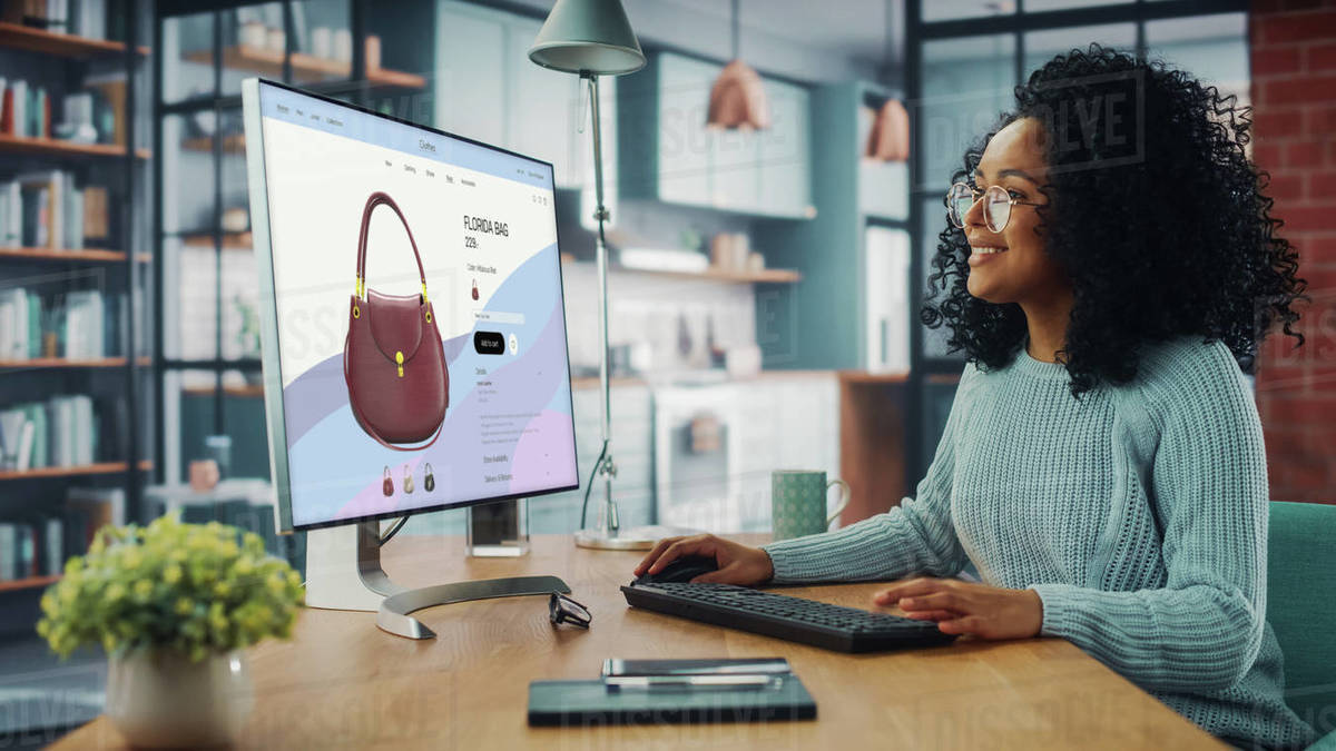 Latina Female Using Desktop Computer with Clothing Online Web Store to ...