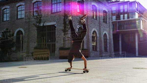 Agile Professional Skater Stands on the Hands on His Skateboard. Strong ...