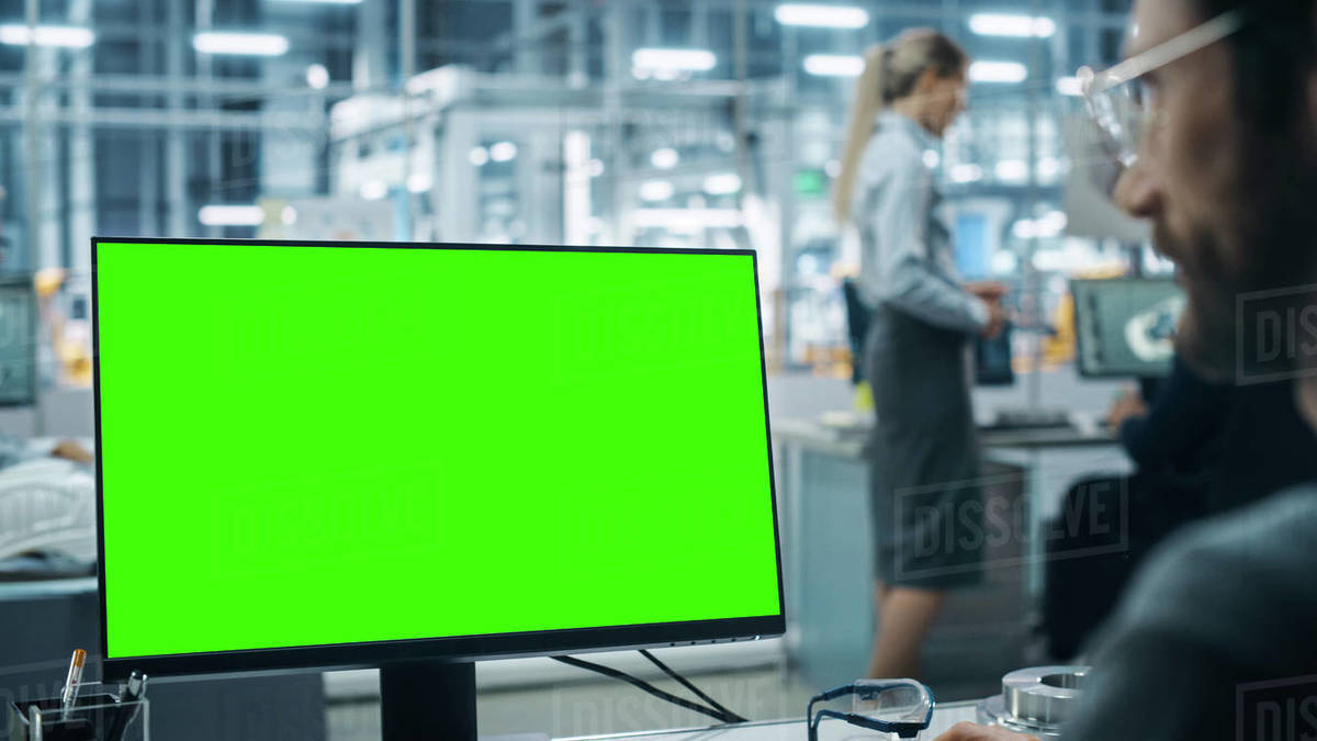 Caucasian Male Automotive Engineer Sitting at His Desk Working on Green ...