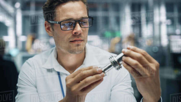 Close Up Portrait of Young Engineer in Glasses Working on Manufacturing ...