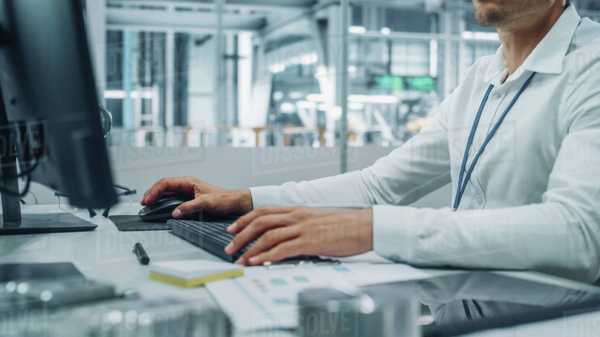 Automotive Engineer Working on Desktop Computer in Modern Office at Car ...