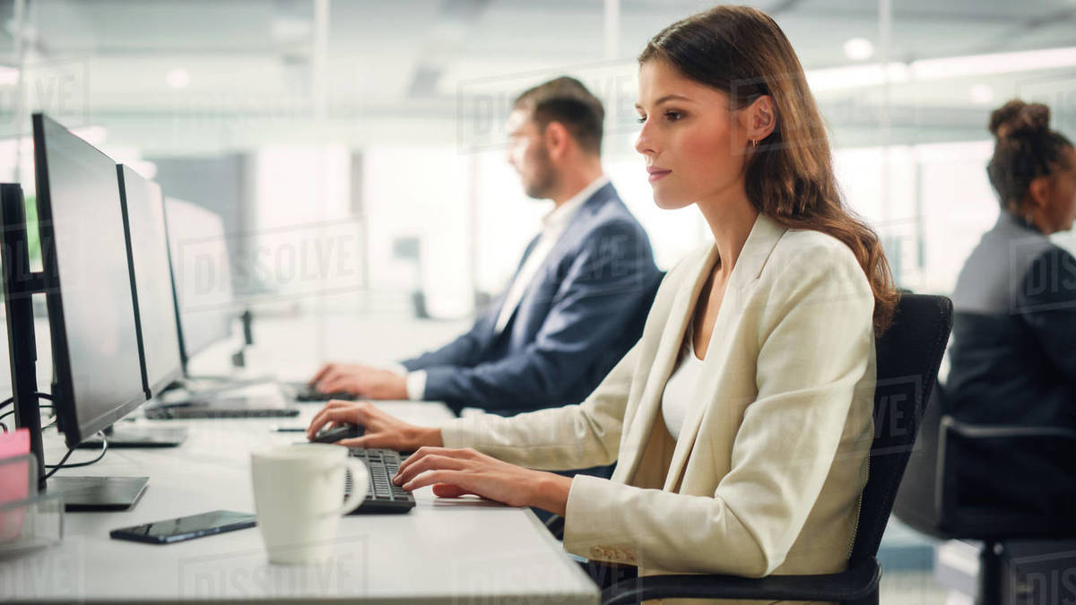Young Businesswoman Using Desktop Computer in Modern Office with ...