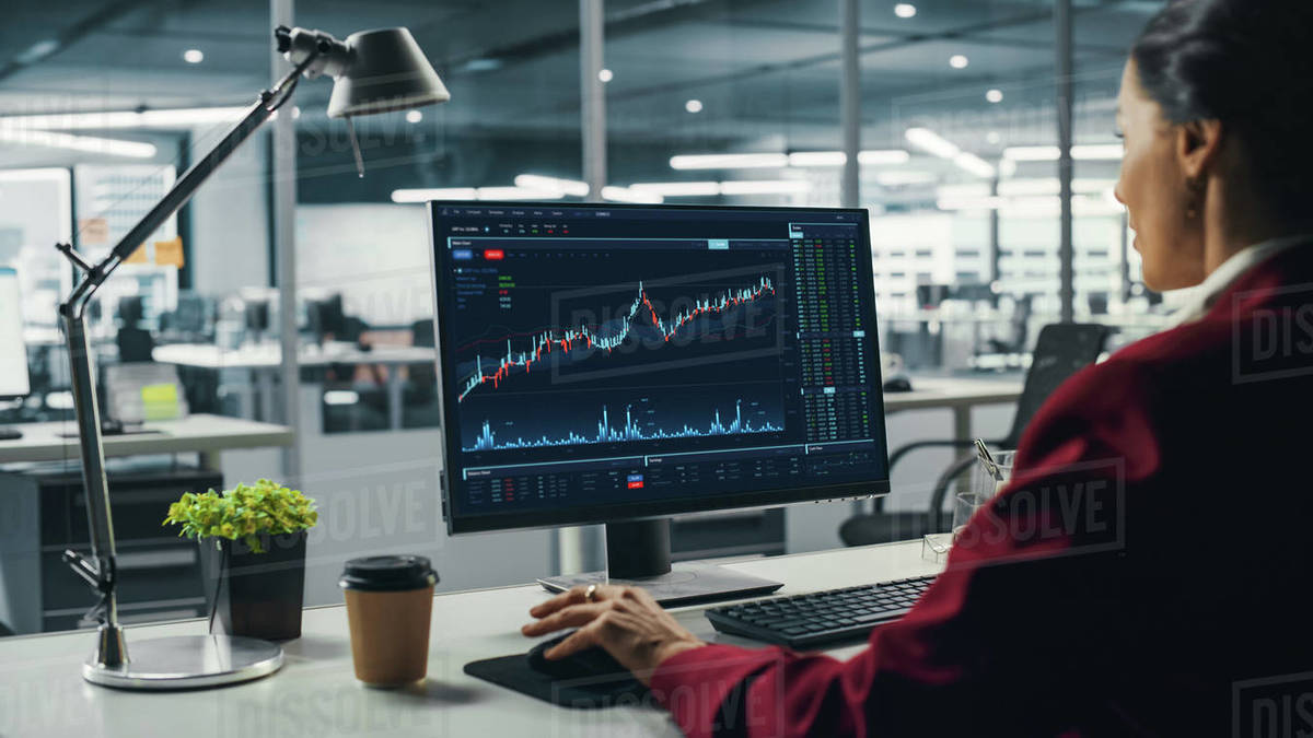 Business Woman Sitting at Desk Working on Desktop Computer in City ...