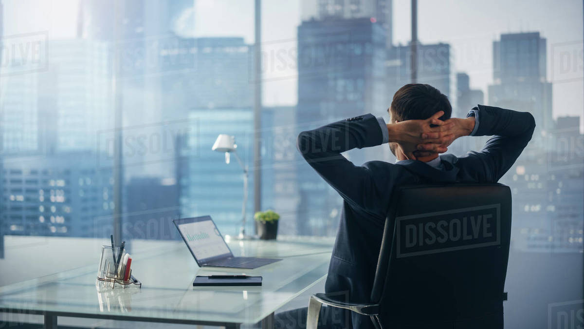 Businessman in a Suit Sitting at a Desk in Modern Office - Royalty-free ...