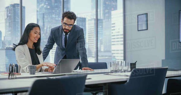 Corporate CEO Sitting at Her Desk Working on Laptop and Consulting Top ...